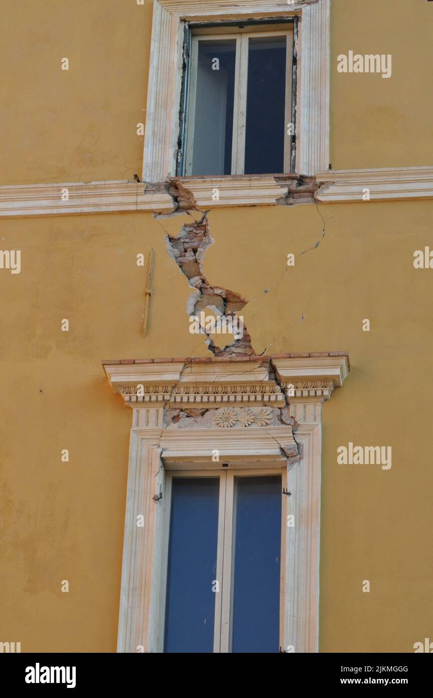 A vertical shot of the cracks on a wall of an old building following ...