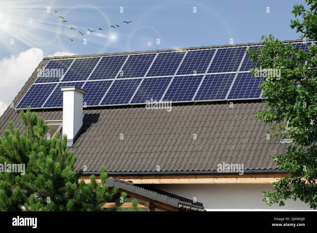 Solar panels on rooftop against blue sky and sun. Solar panels on the ...