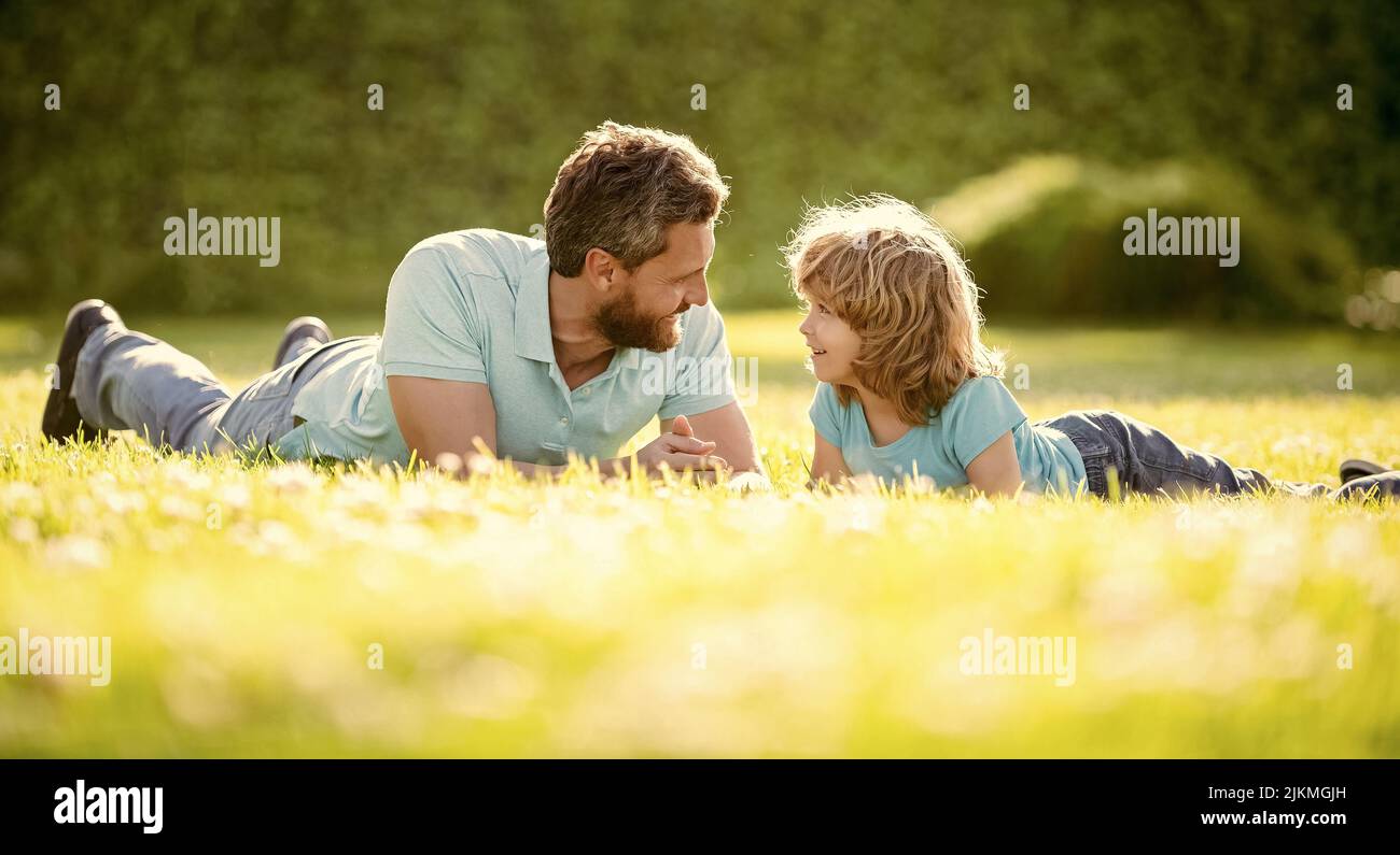 happy father and son having fun in park. family value. childhood and ...