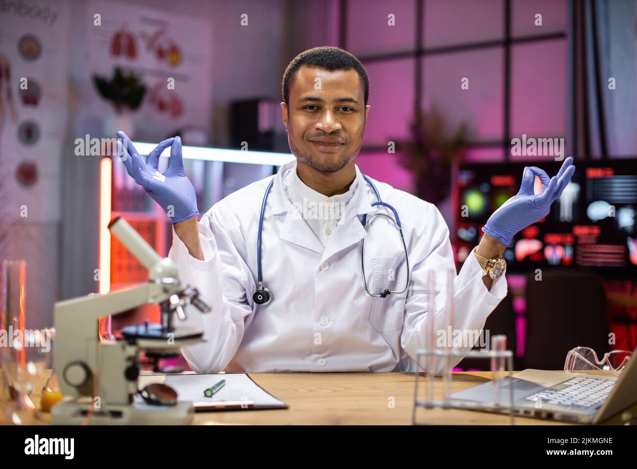Yong african american male scientist relaxing practicing yoga wearing ...