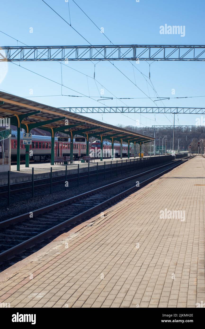 A view of an empty train station against a clear blue sky in Kaunas Stock Photo - Alamy