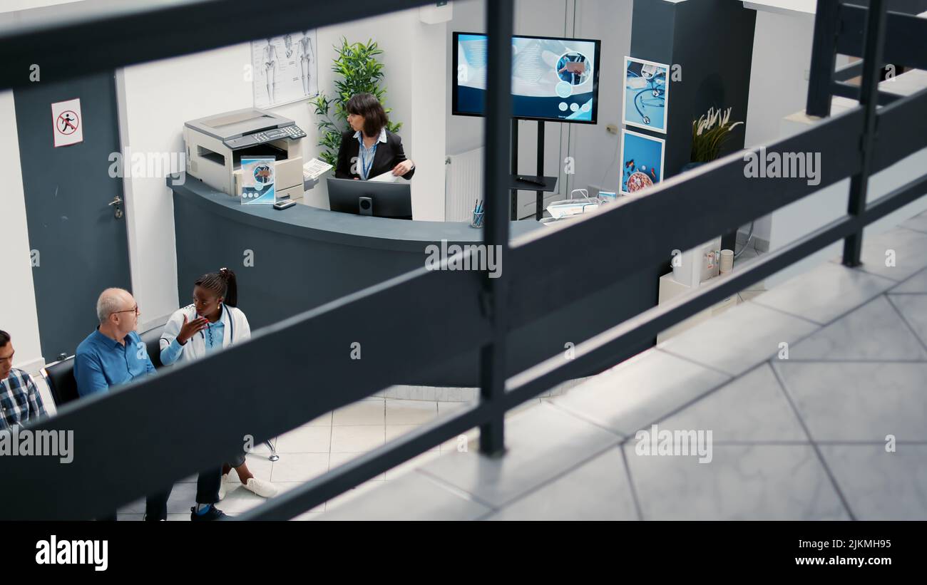 Lady receptionist working at hospital reception desk to help patients ...