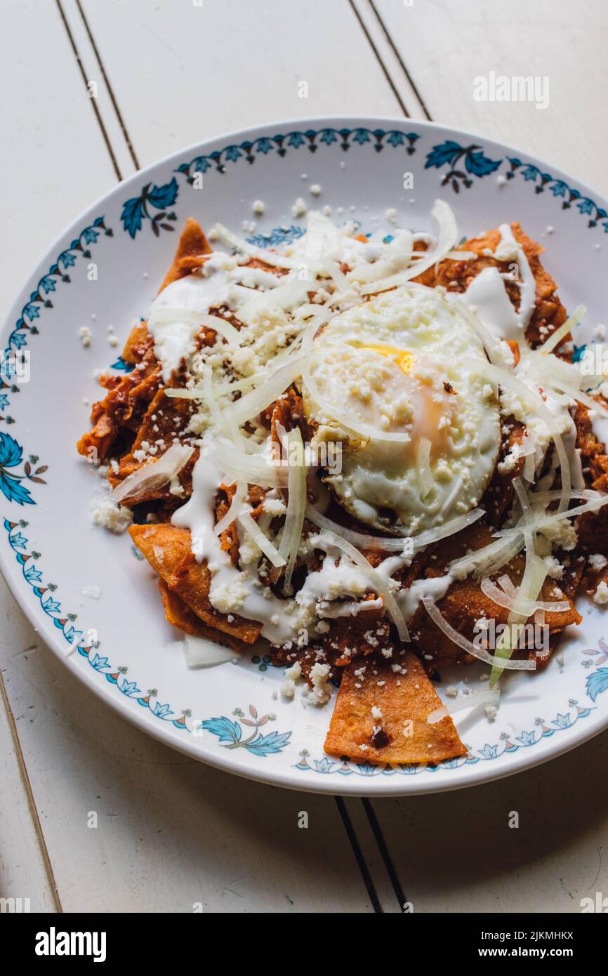chilaquiles rojos mexican breakfast on blue and white floral plate ...