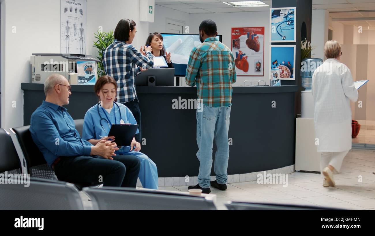 Busy hospital reception desk with diverse people in waiting room, asian ...