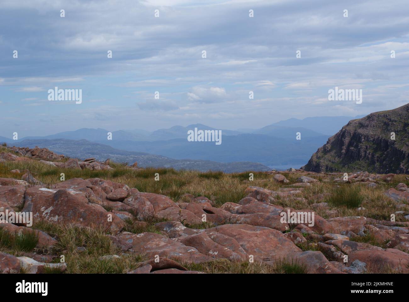 A beautiful shot of some huge rocks on the ground surrounded by grass ...