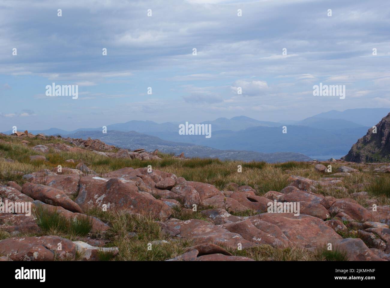 A beautiful shot of some huge rocks on the ground surrounded by grass ...