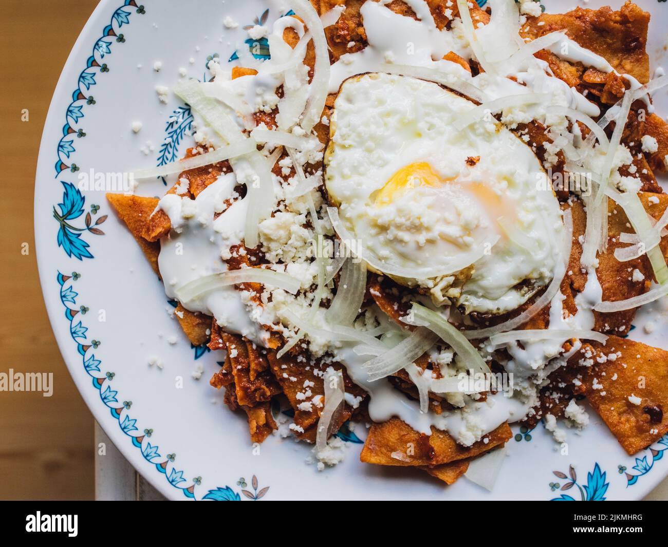 chilaquiles rojos mexican breakfast on blue and white floral plate ...