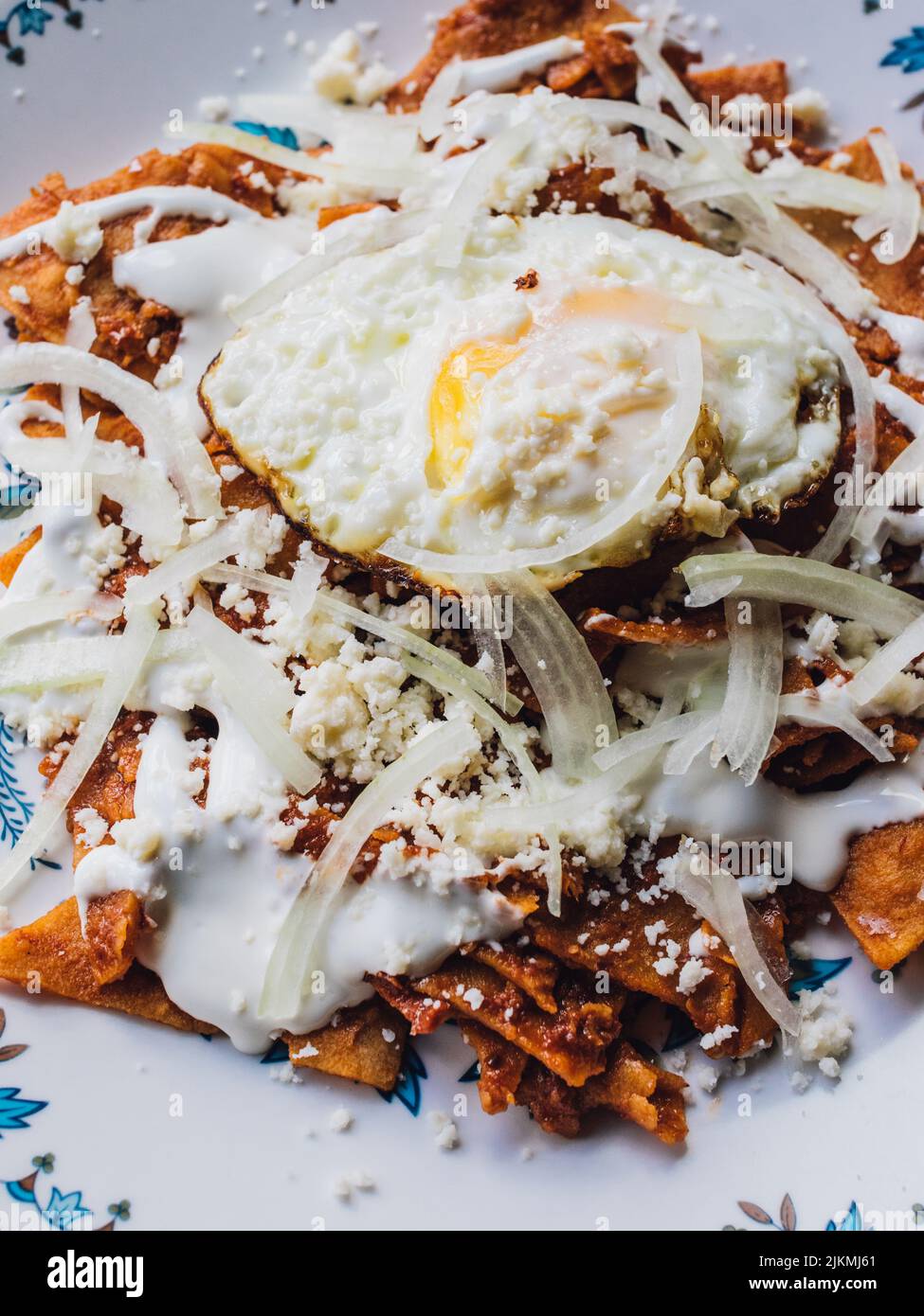 chilaquiles rojos mexican breakfast on blue and white floral plate ...
