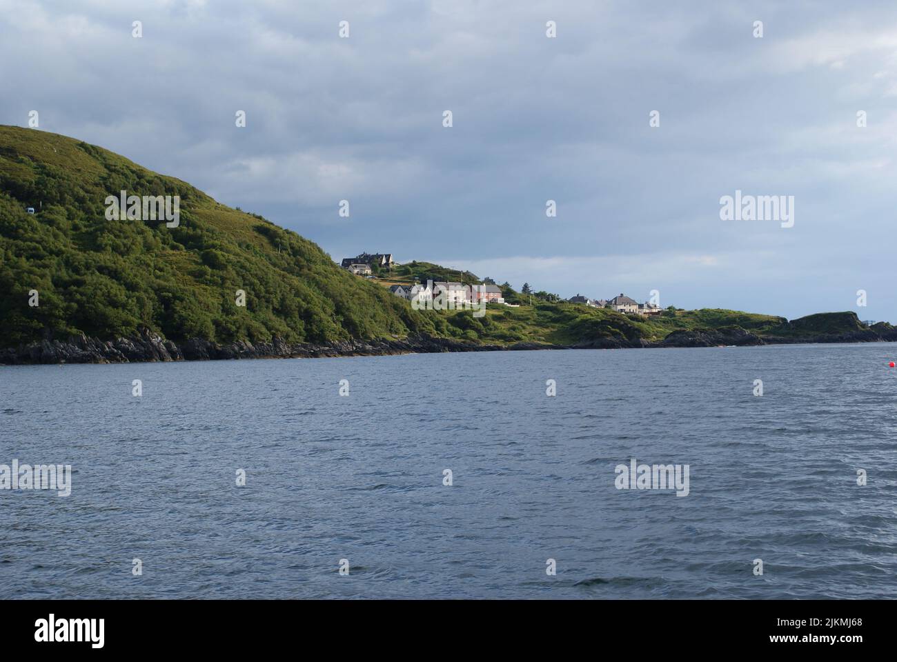 A beautiful view of sea waves with mountains background under a cloudy ...
