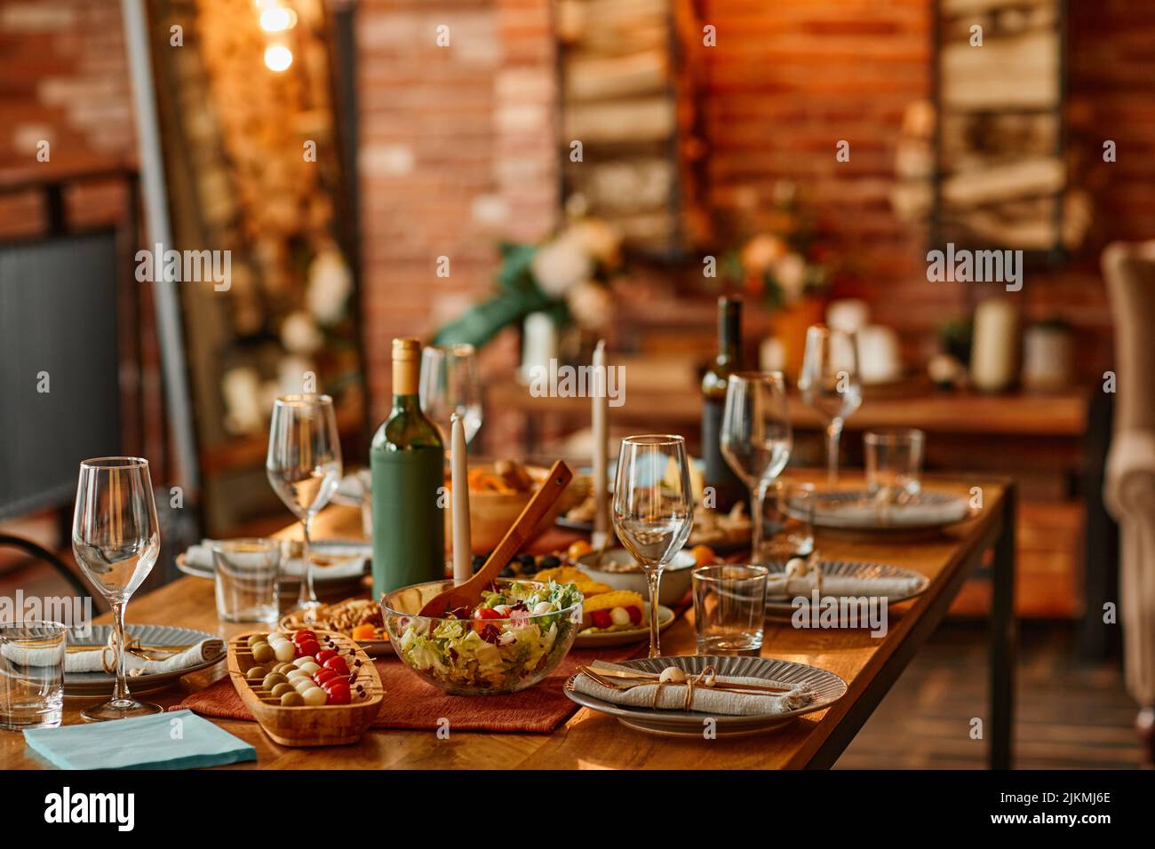 Warm toned background image of wooden dinner table set with dishes for ...