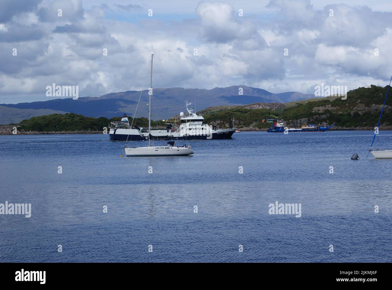 A beautiful view of boats moored on the sea under a cloudy sky in ...