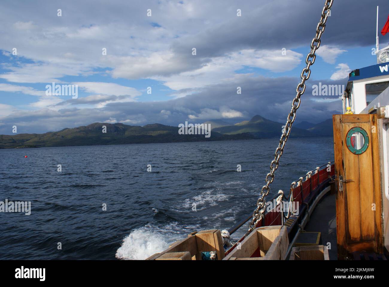 A beautiful view of waves on the sea behind a boat in Scotland Stock ...