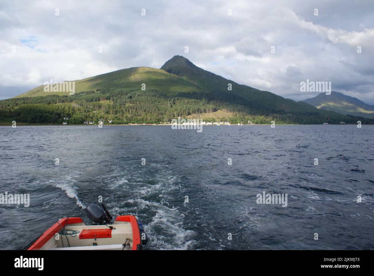 A beautiful view of waves on the sea behind a boat in Scotland Stock ...
