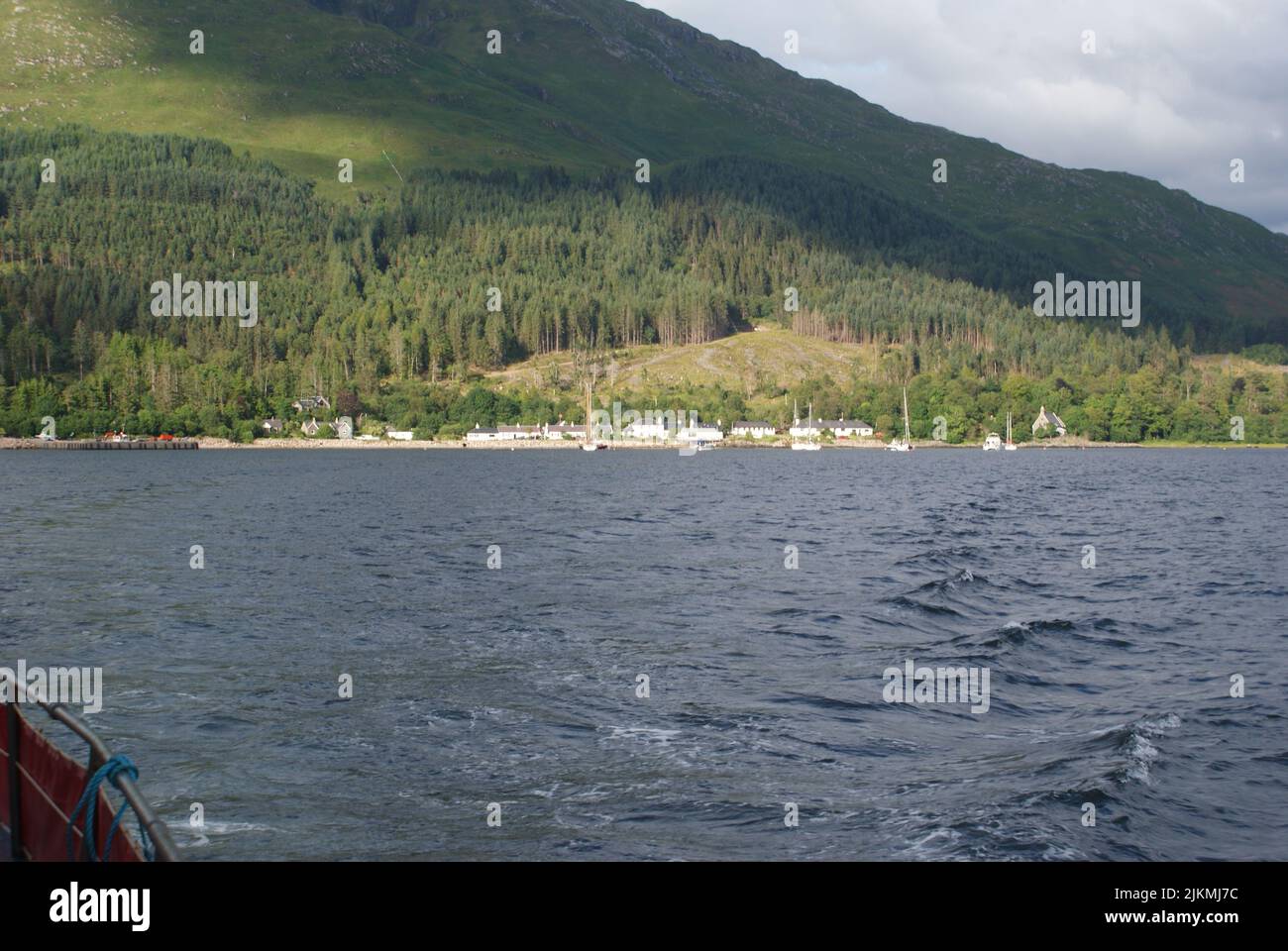 A beautiful view of waves on the sea behind a boat in Scotland Stock ...