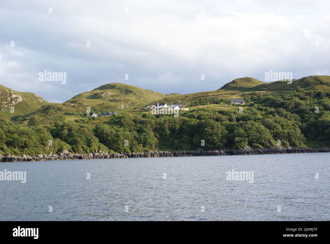 A beautiful view of sea waves with mountains background under a cloudy ...
