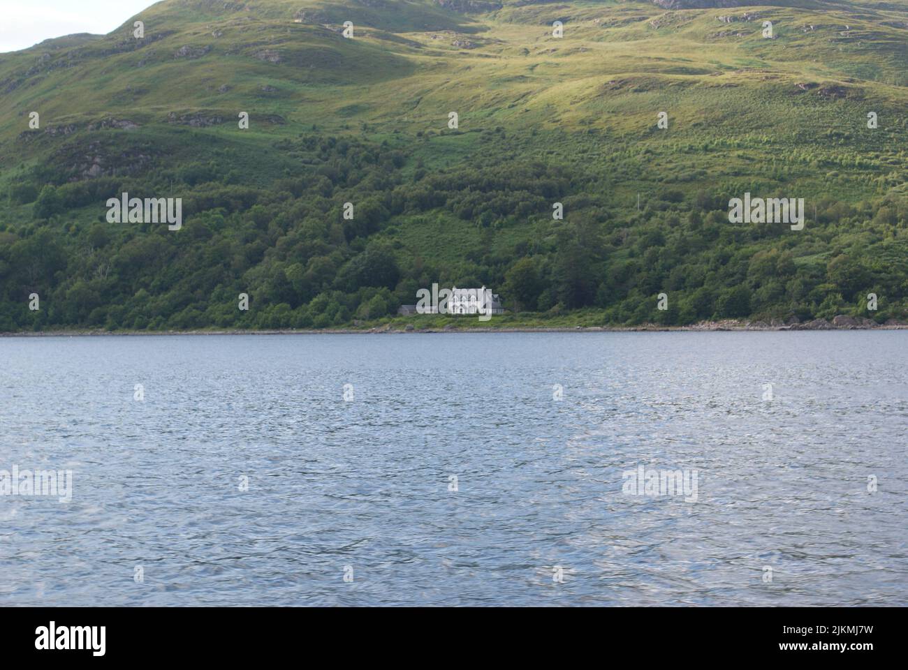 A beautiful view of sea with a house background on a hill in Scotland ...