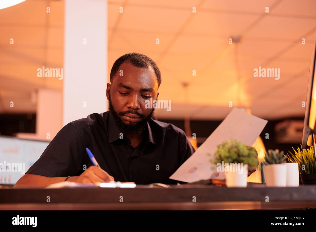 African american employee taking notes about startup contract ...