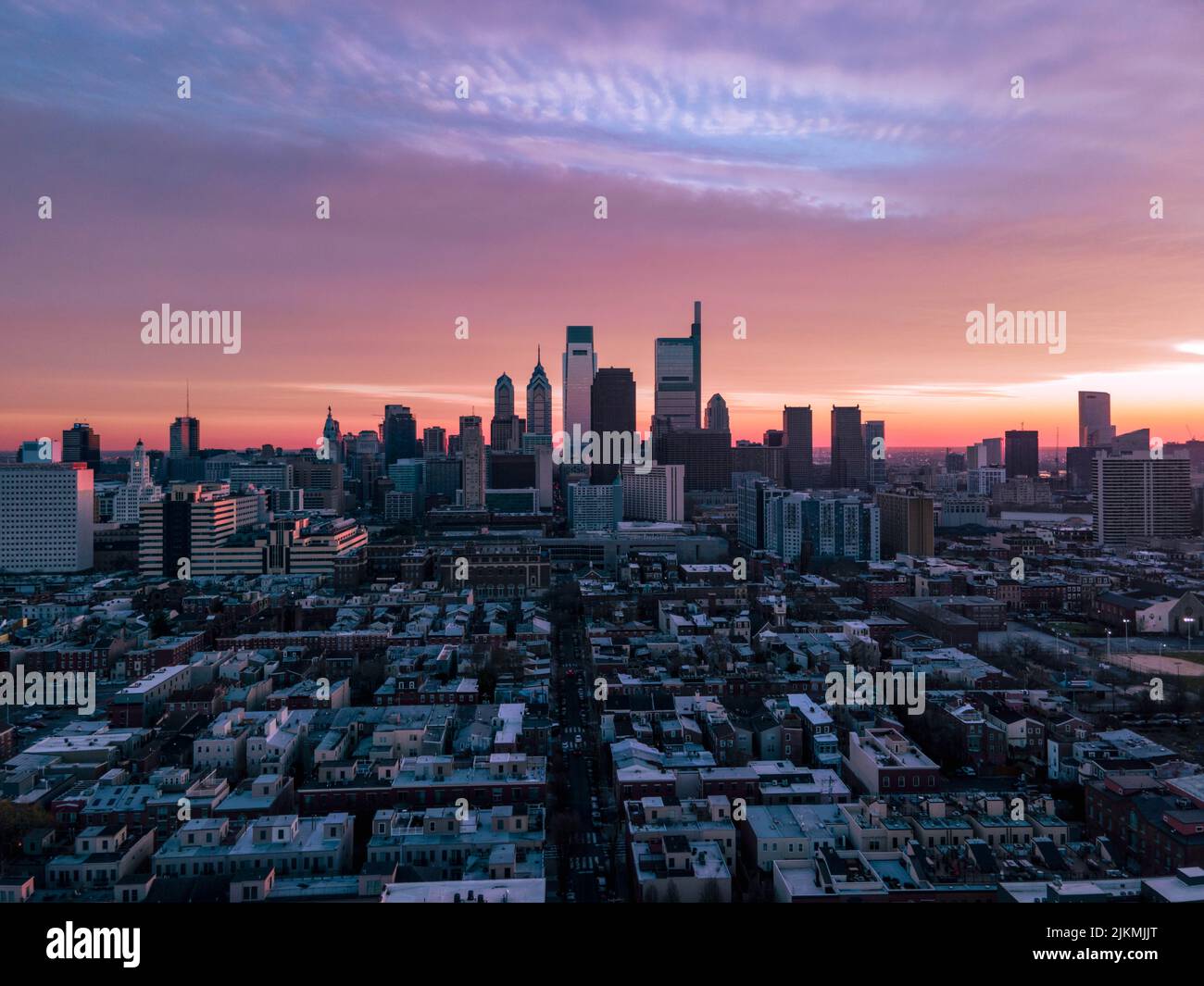 A scenery of houses and high-rise buildings at sunset Stock Photo - Alamy