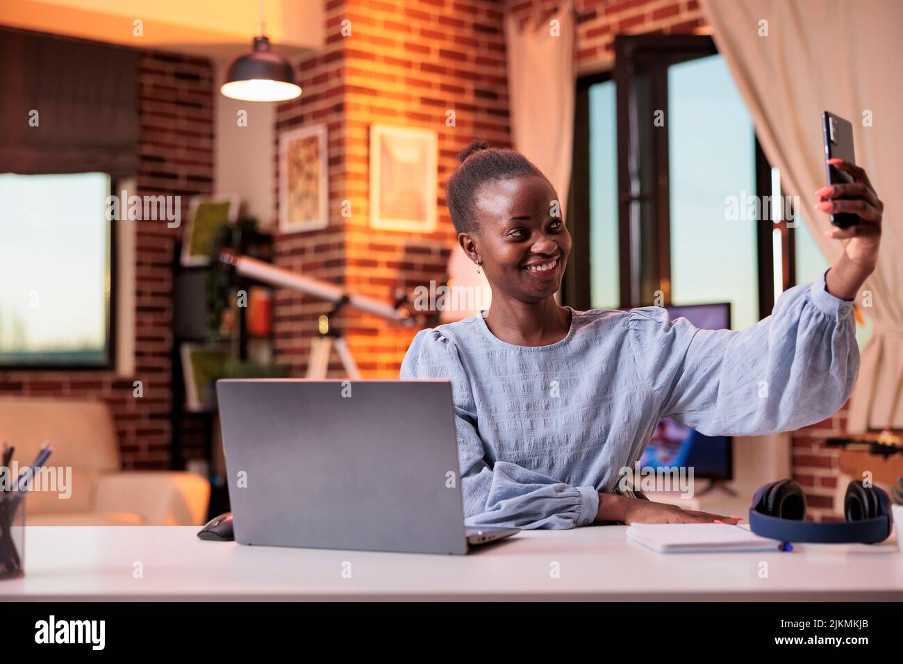 Young african american woman taking photo on smartphone in modern ...