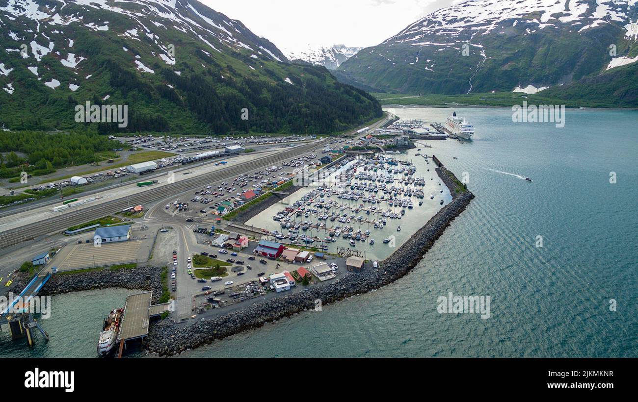 An aerial view of the harbor in Whittier, Alaska, with a cruise ship in ...