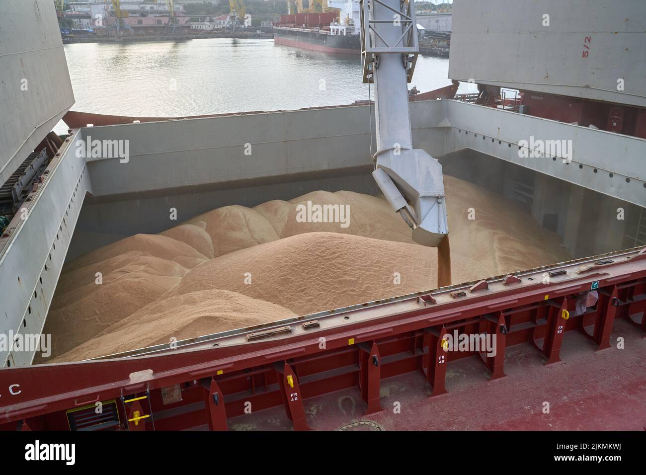 loading corn onto a bulk carrier ship in the port at the grain terminal ...