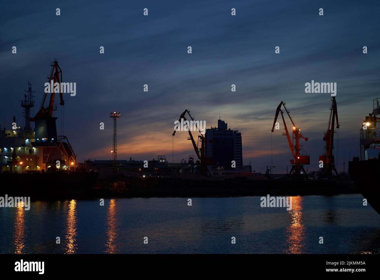 sunset in industrial landscape of commercial seaport. Sunset at seaport ...
