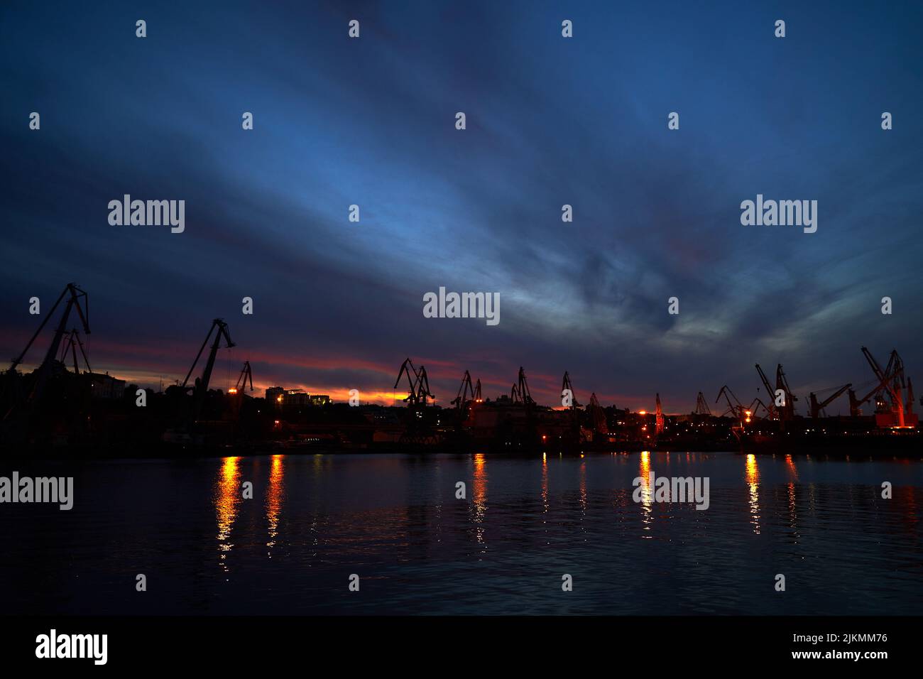 sunset in industrial landscape of commercial seaport. Sunset at seaport ...