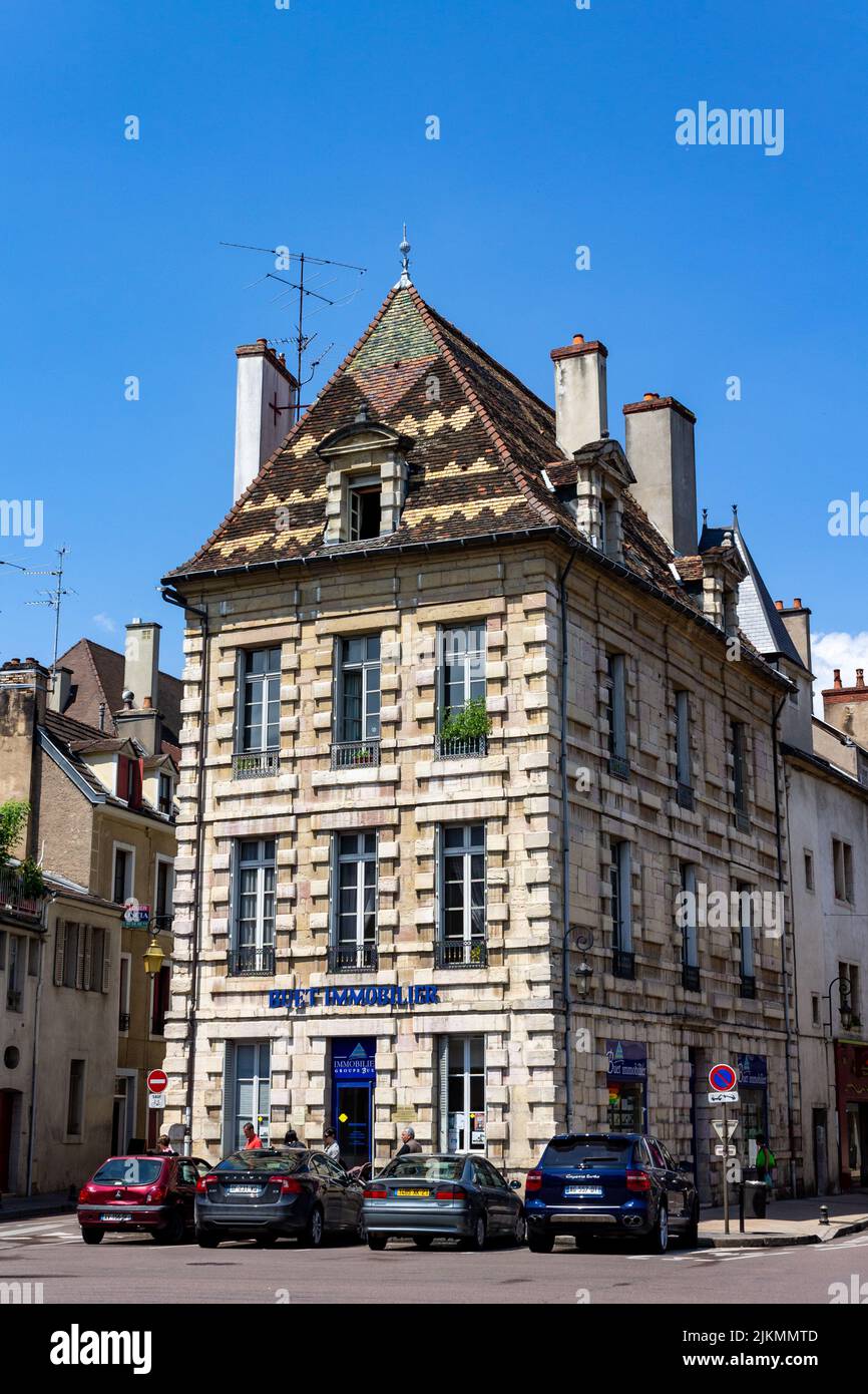 A vertical shot of an old building facade against the sky, the ...