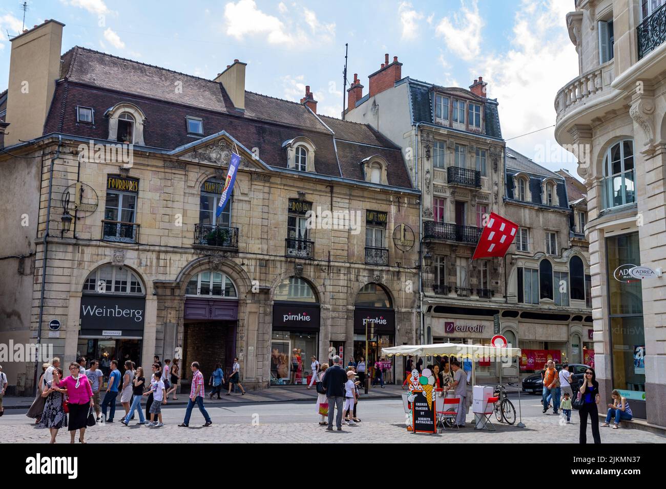 A facade of the historical old buildings and people walking in the ...