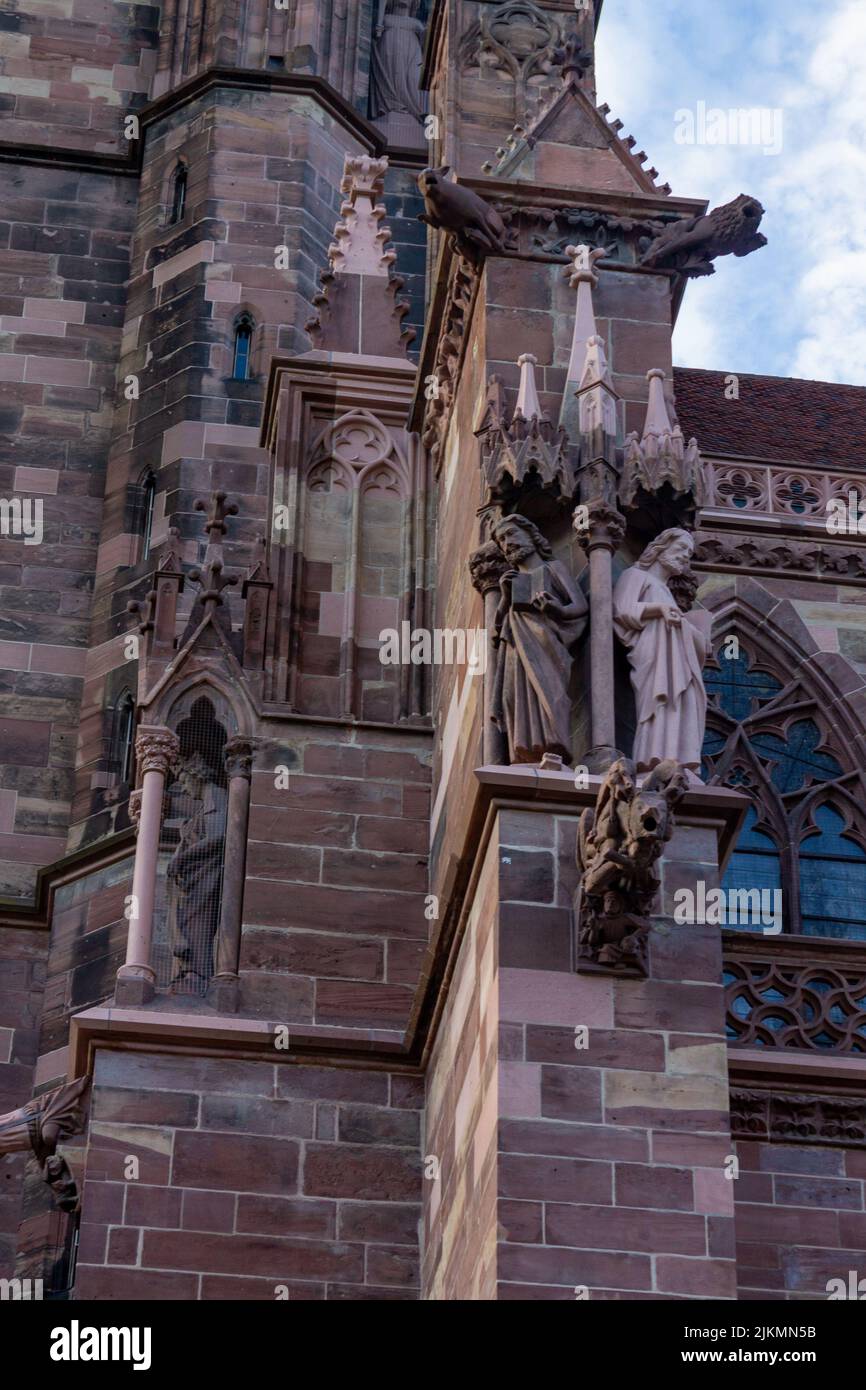 A vertical shot of the detail and the statues at the facade of Freiburg ...