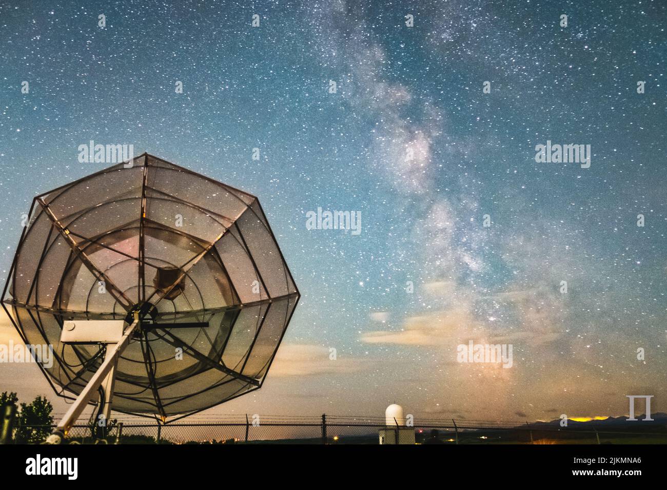 A view of a radio telescope on a platform with the sky full of ...