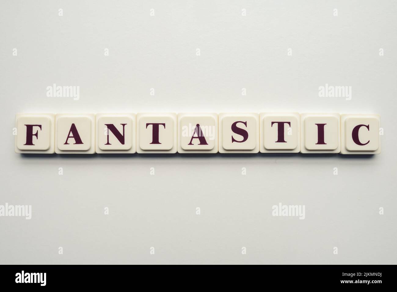 A closeup of scrabble tiles with letters spelling the message ...