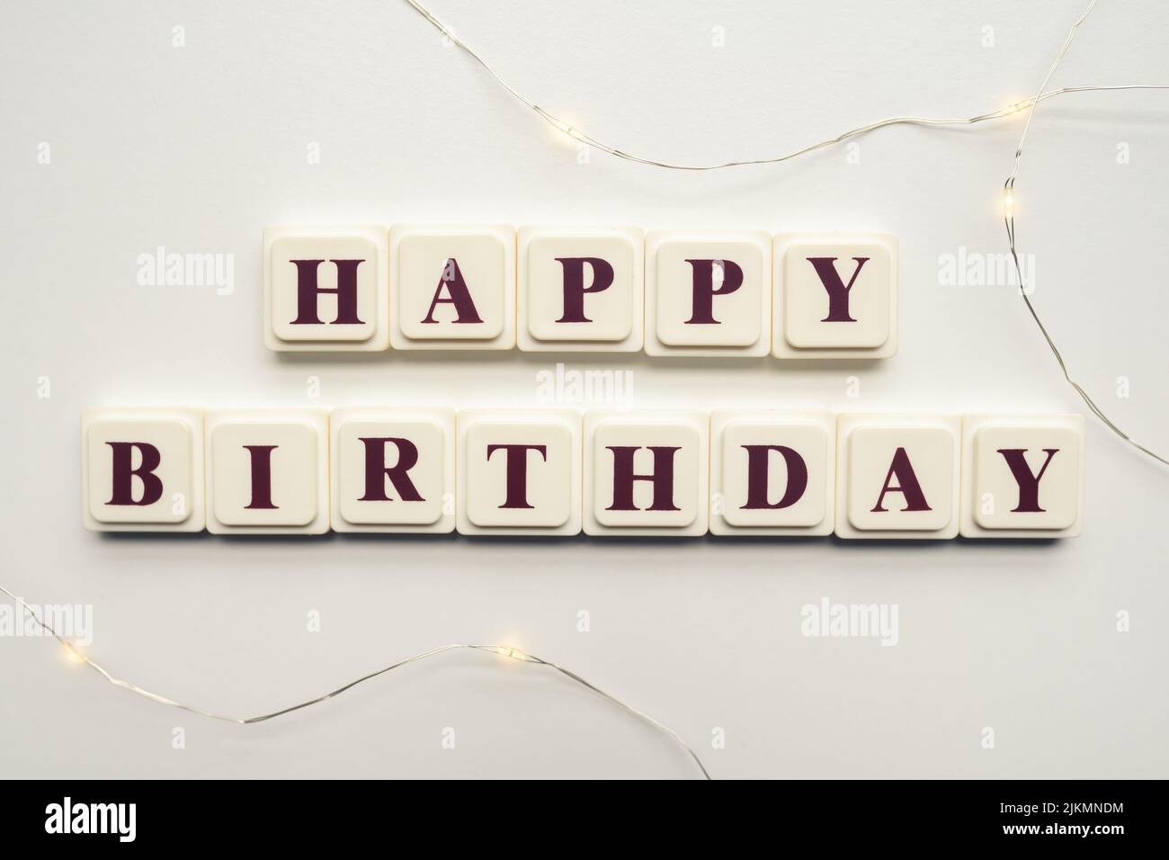 A closeup of scrabble tiles with letters spelling the message "Happy ...