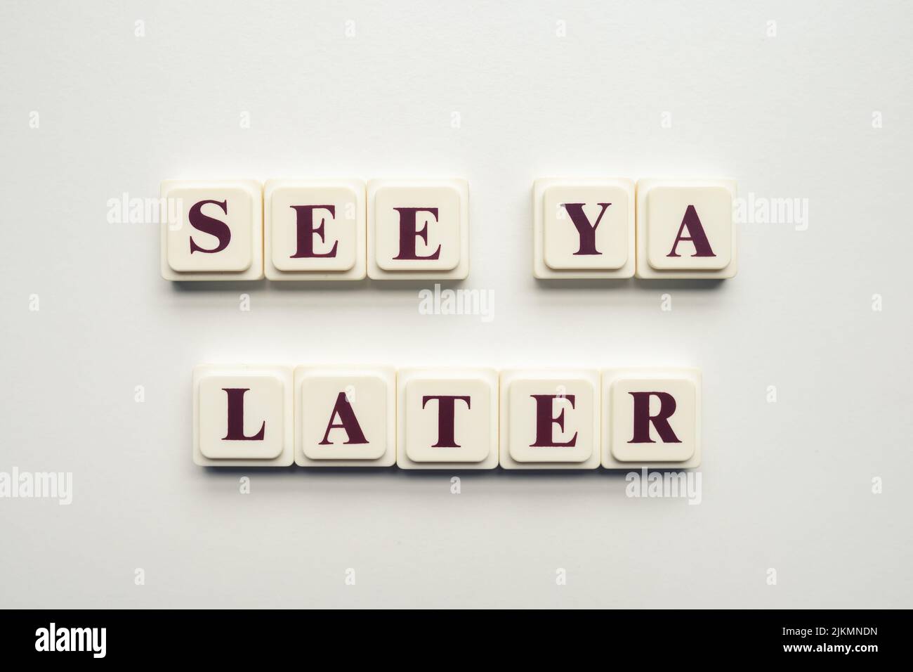 A closeup of scrabble tiles with letters spelling the message "See Ya ...