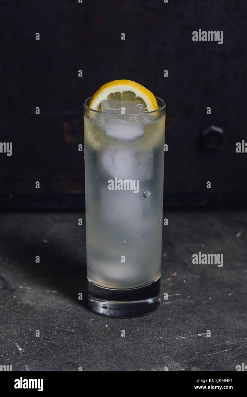 tom collins soda water cocktail in tall glass with lemon wheel, ice ...