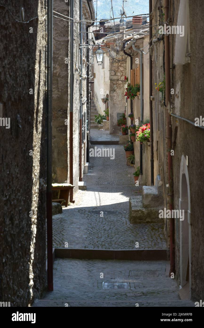A narrow street among the houses of Villalago, a medieval village in ...