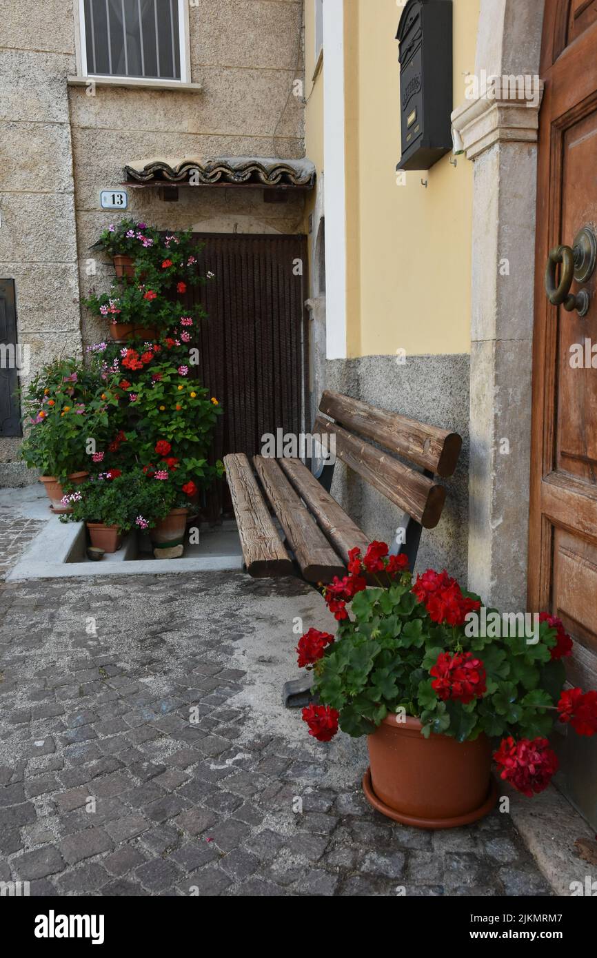 The door of an old house with a wooden bench in Castrovalva, a town in ...