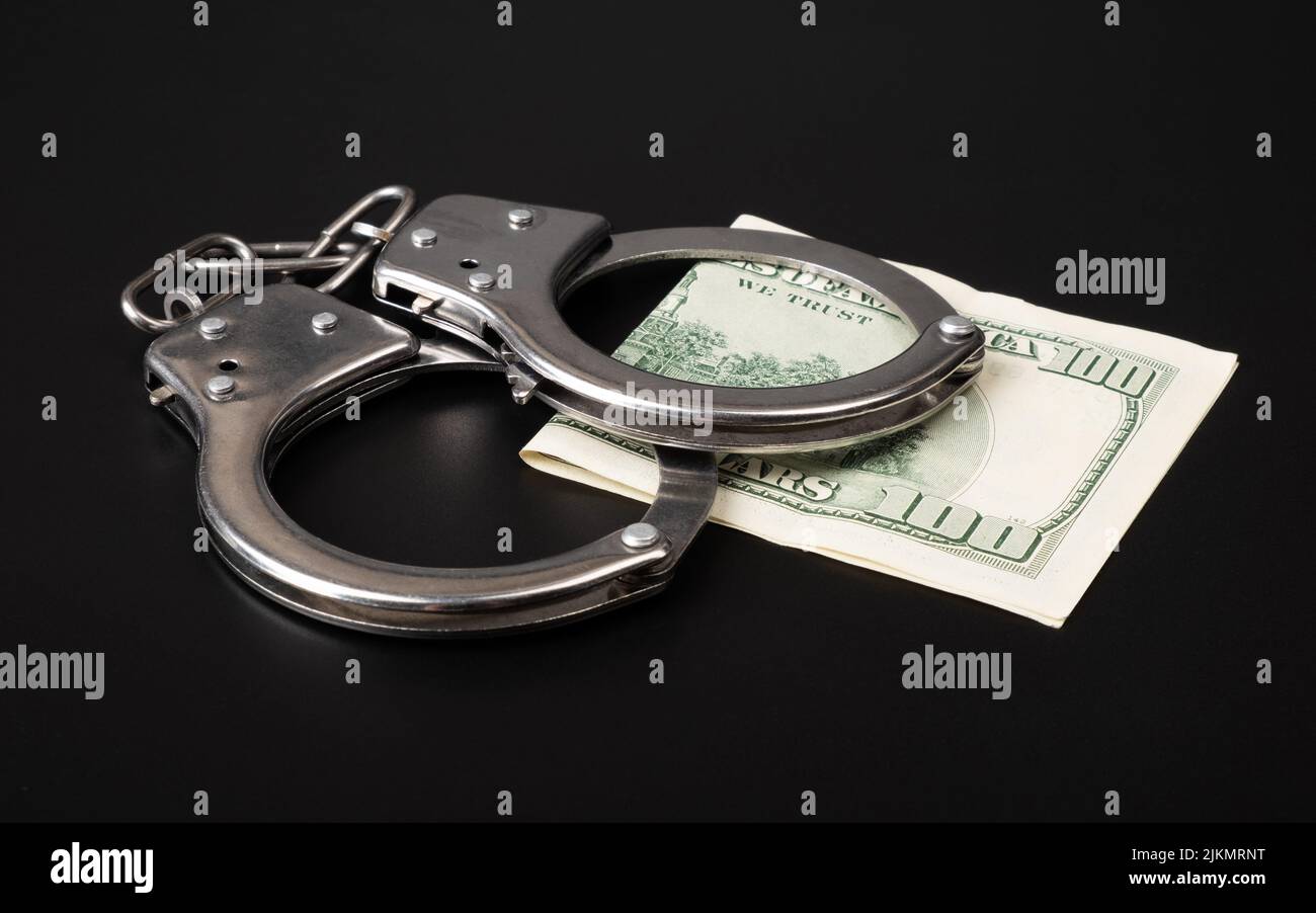 fraud and money laundering crime, handcuffs and dollars Stock Photo - Alamy