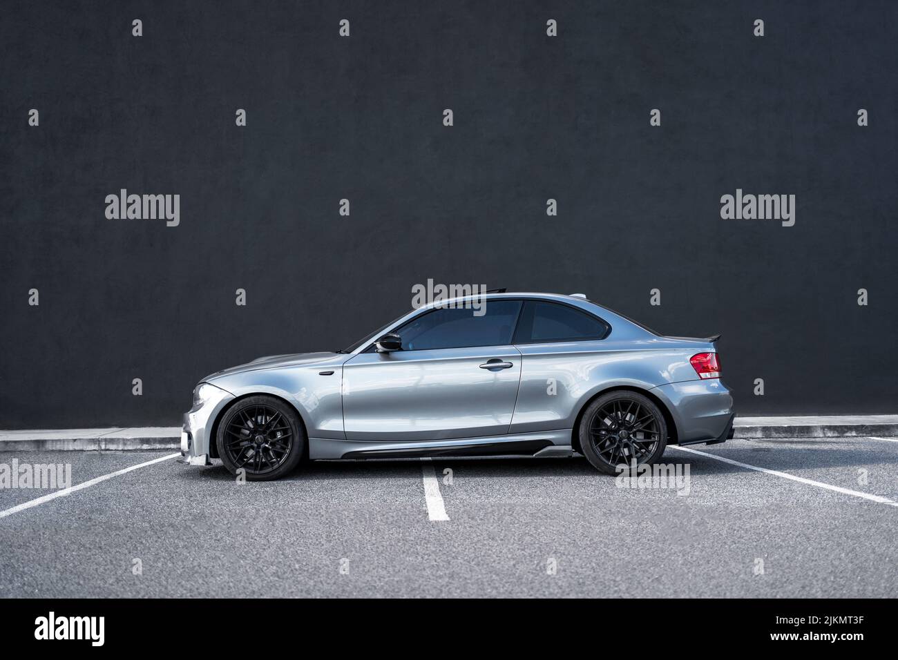A side profile of a silver BMW 1 series parked in a parking lot Stock ...