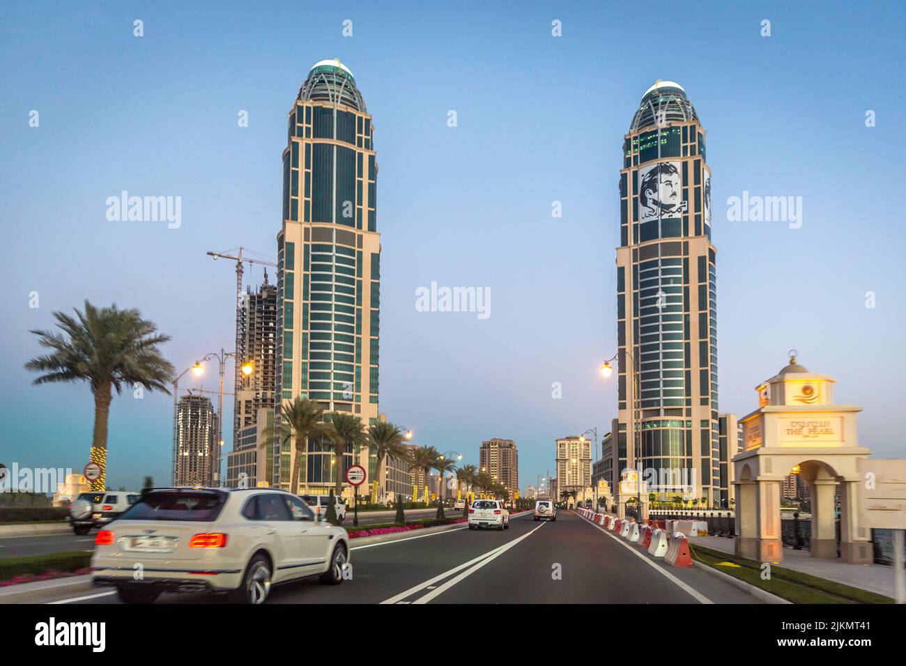 Doha, Qatar - 2018, January 19th - Cars driviing in a road with two big ...