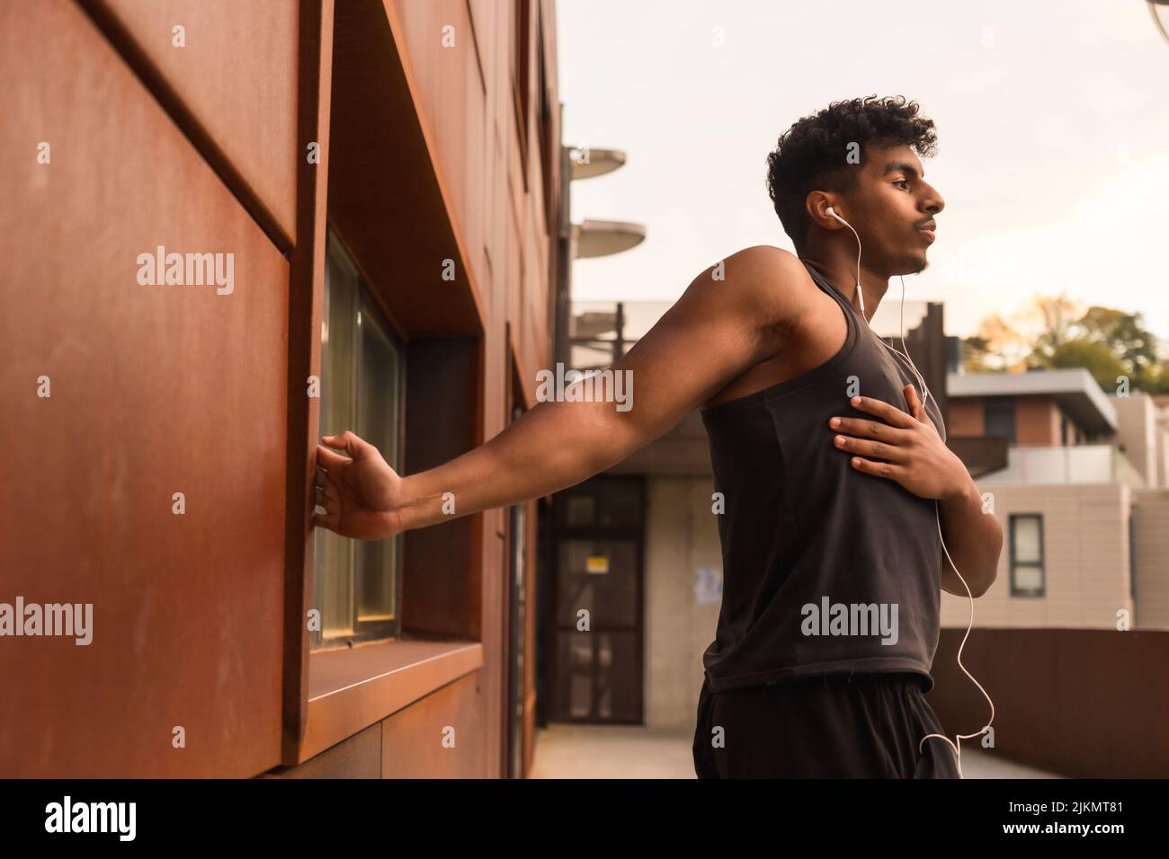 Arab strong young man doing arm stretching exercises before sport in ...