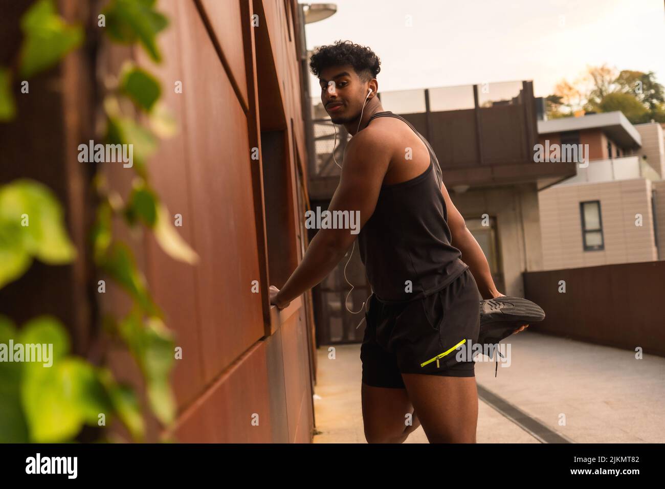 Smiling young athlete doing exercises hi-res stock photography and ...