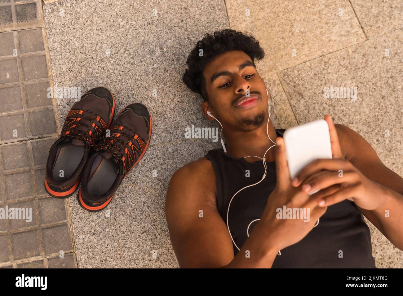 Young man lying on concrete hi-res stock photography and images - Alamy