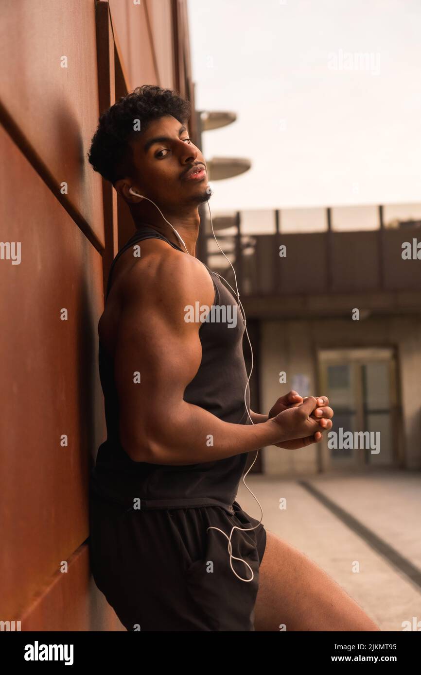 Arab young man doing sport exercises in the city, pose of the strong ...