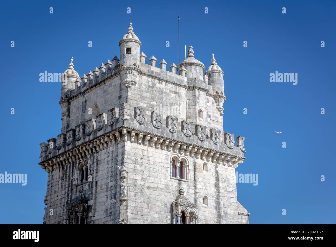 Belem tower in Portugal with an small airplane in a blue sky day Stock ...