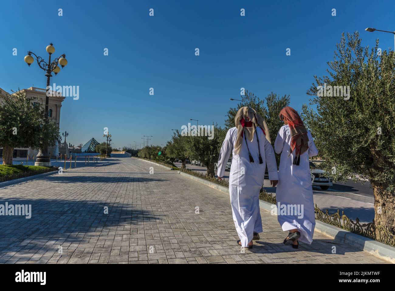 Doha, Qatar - 2018, January 19th - two qatari male walking in ...