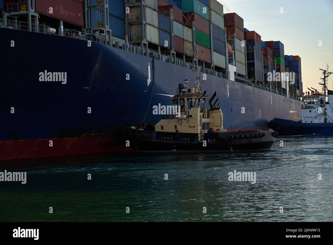 A large merchant ship container vessel in coastal waters of ocean. A ...