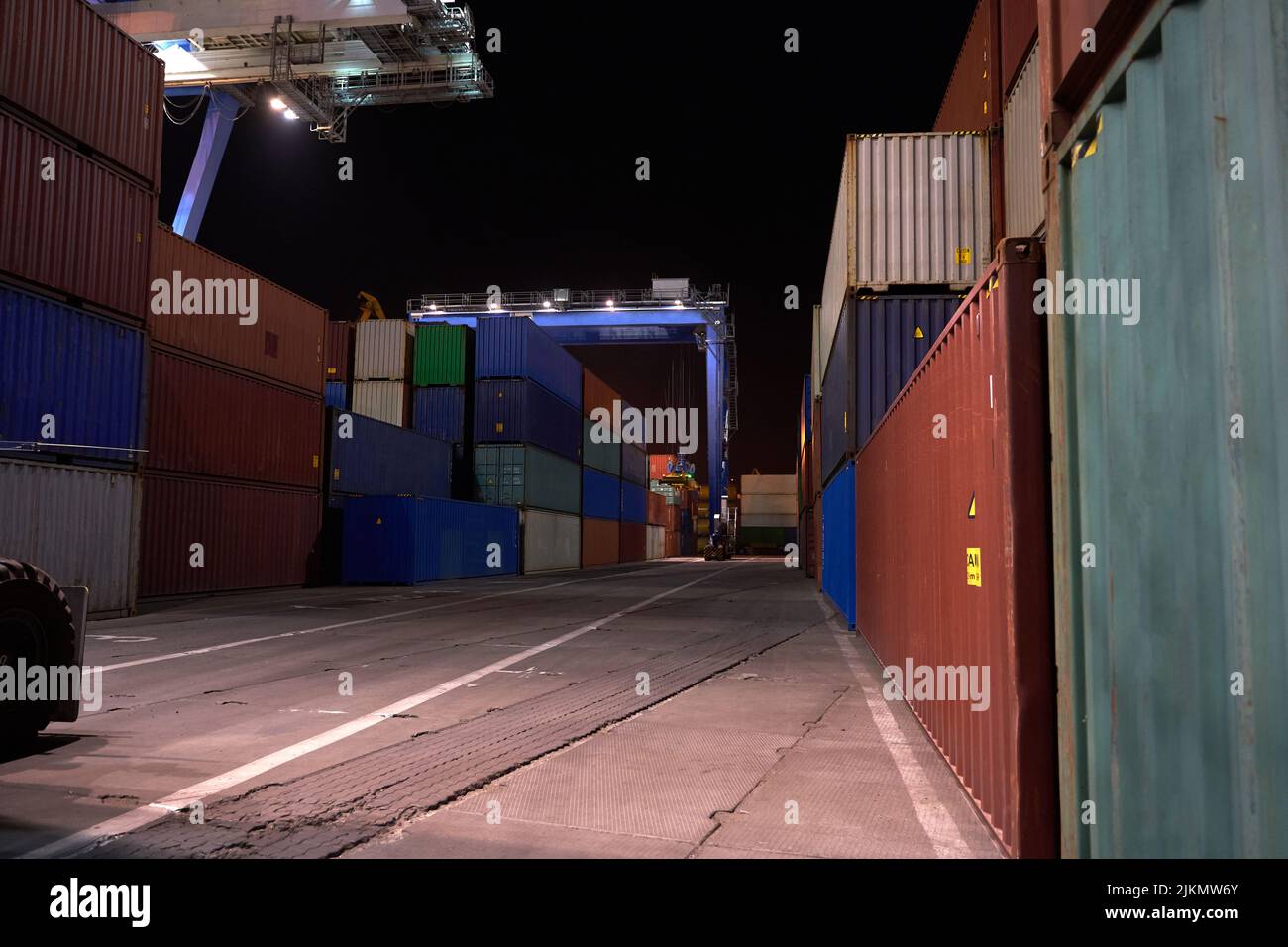 operation of container terminal at night. Unloading container ship at ...