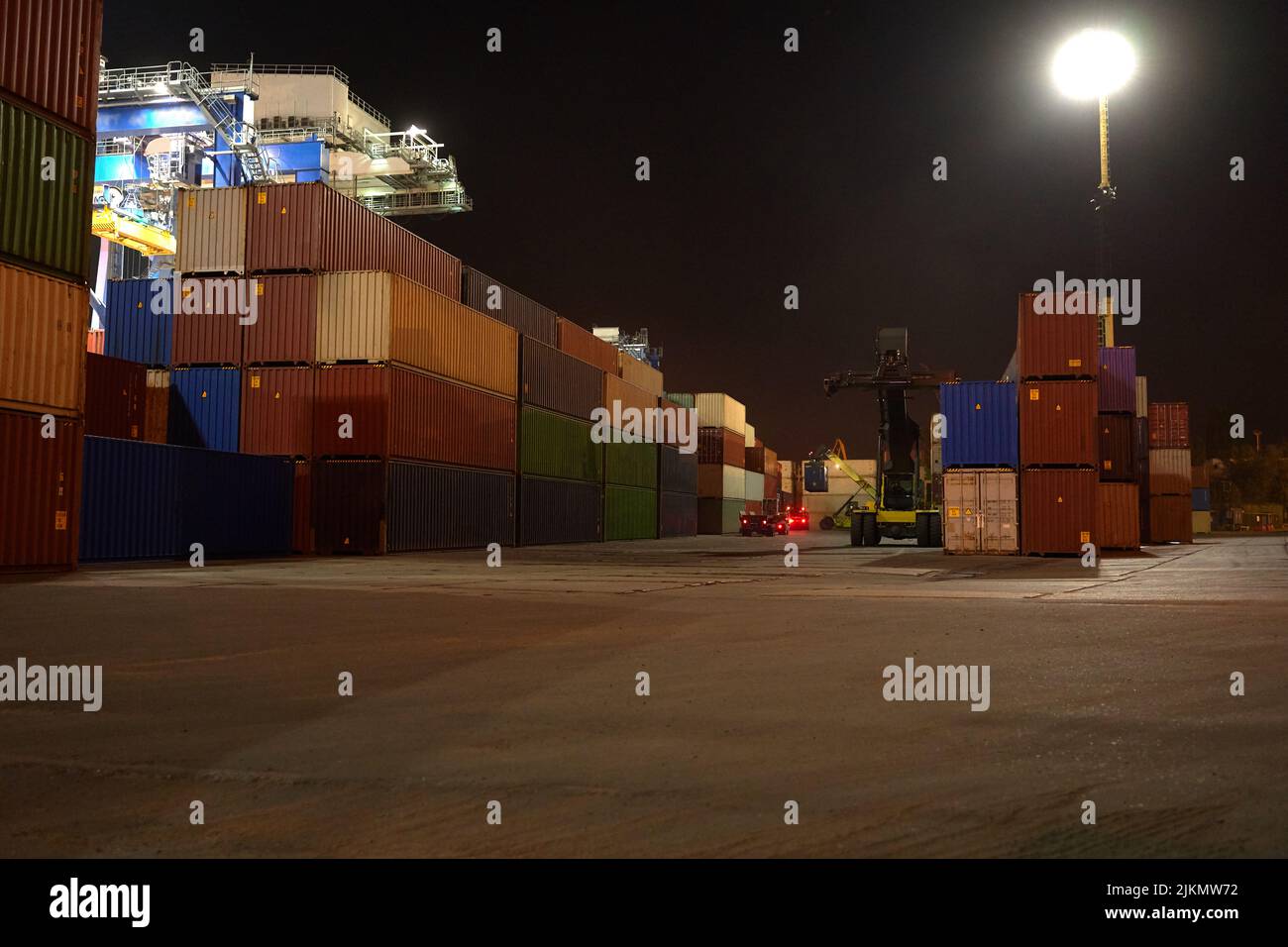 operation of container terminal at night. Unloading container ship at ...