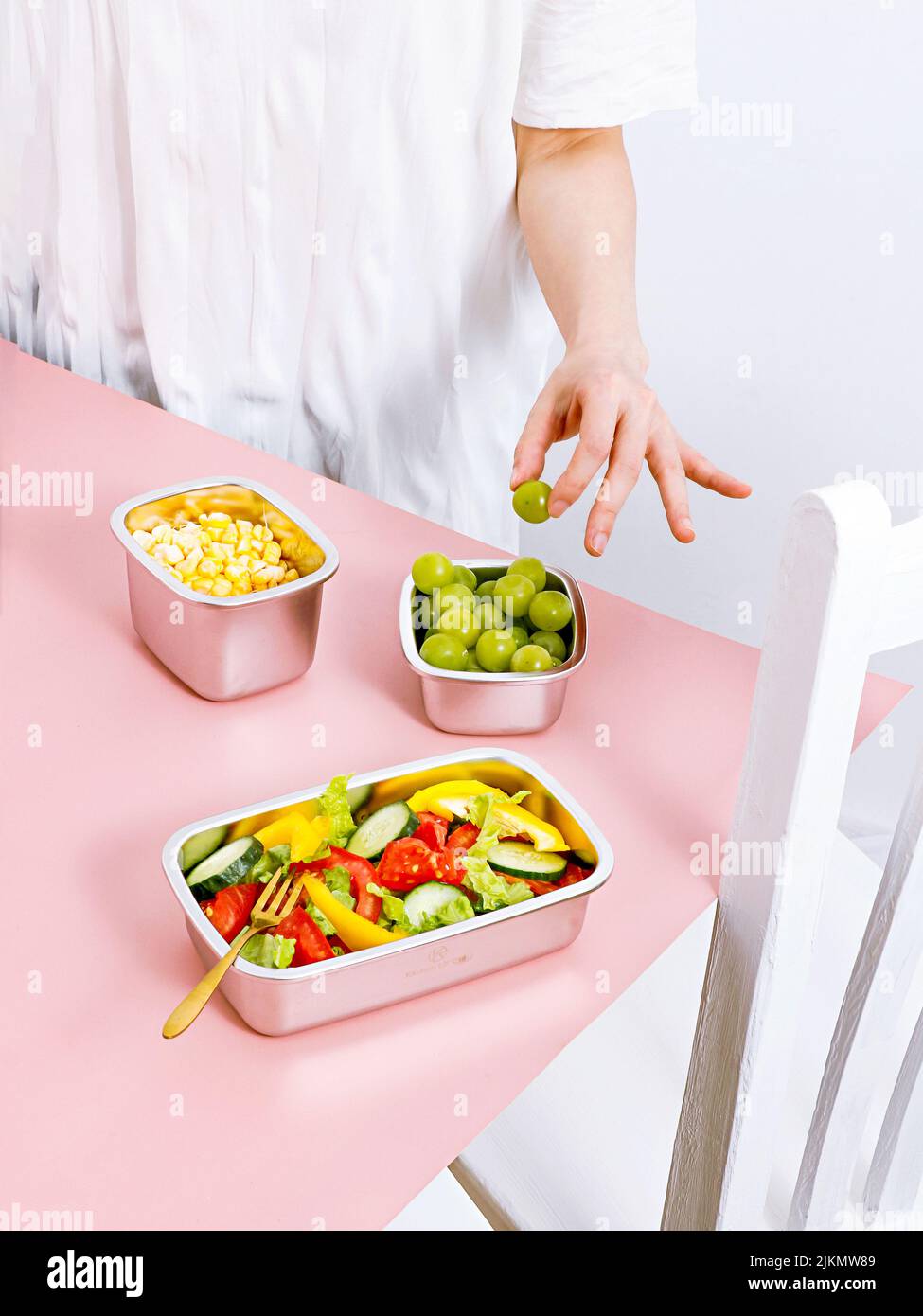 A vertical shot of person eating a healthy salad from a container Stock ...
